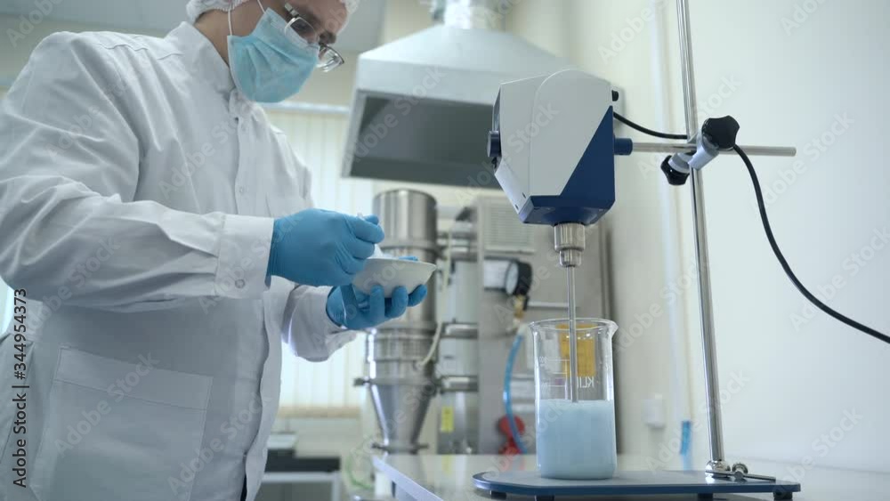 Video Stock man scientist making experiment with mixing liquid and ...