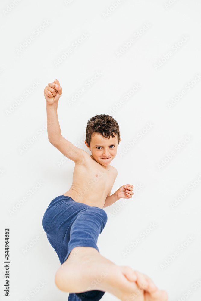 Boy kicking. Stock Photo | Adobe Stock