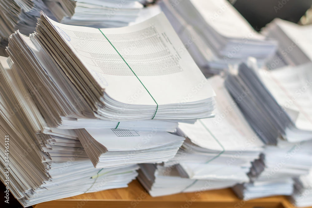 bundles bales of paper documents. stacks packs pile on the desk in the ...