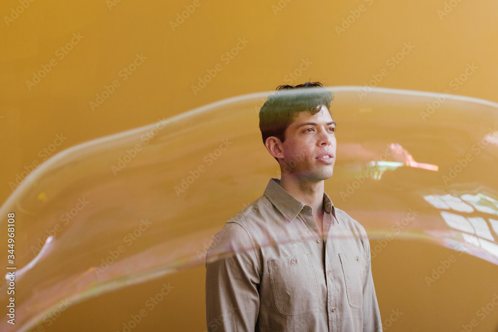 young man with gold background and long bubble in front of face Stock ...