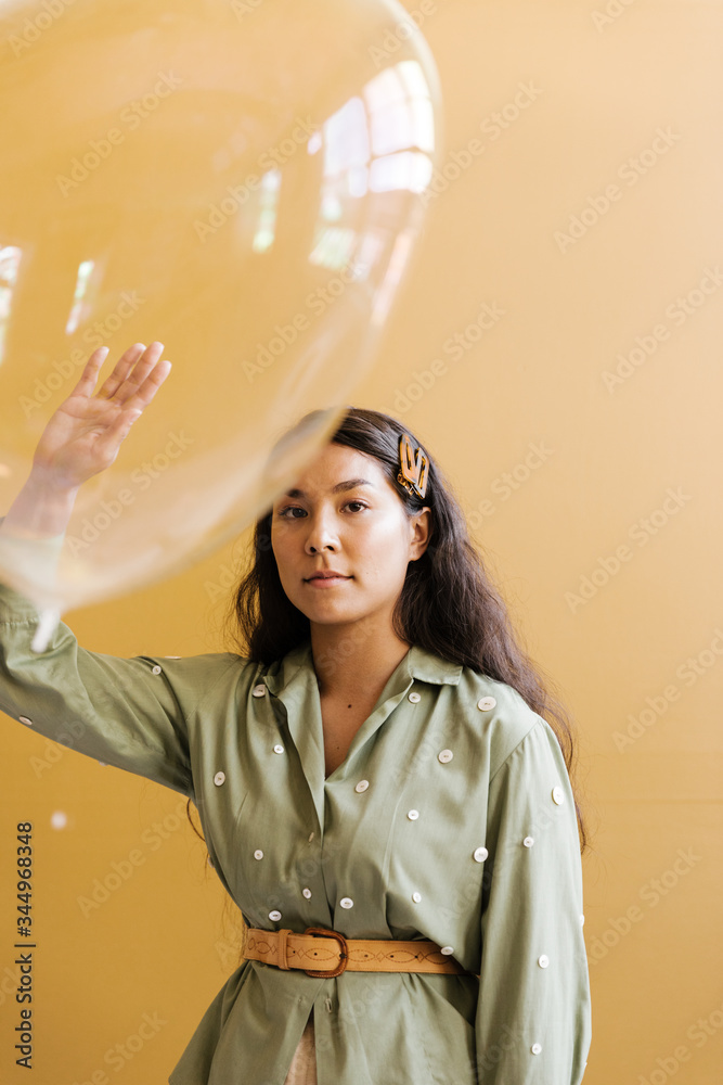 portrait of young woman with giant bubble and gold background Stock ...