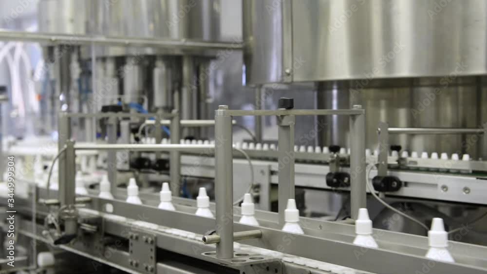 pharmaceutical factory. conveyor with plastic bottles for medicine at ...