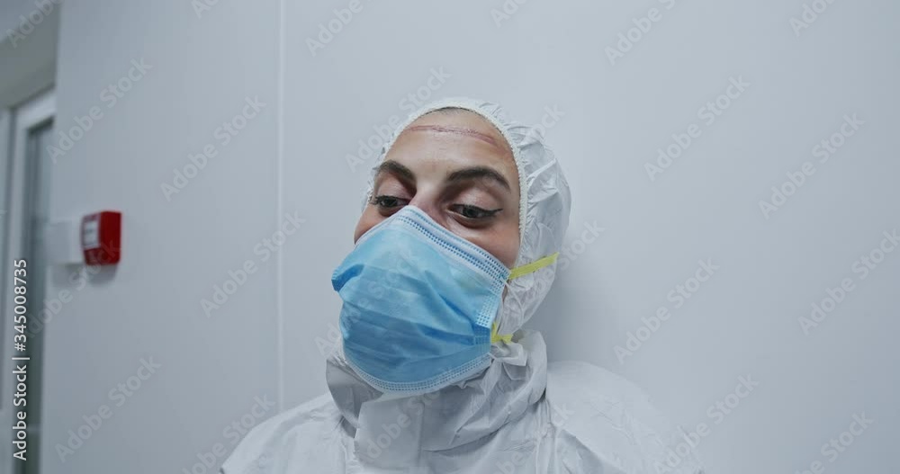 Dramatic video portrait of an exhausted nurse or physician praying ...
