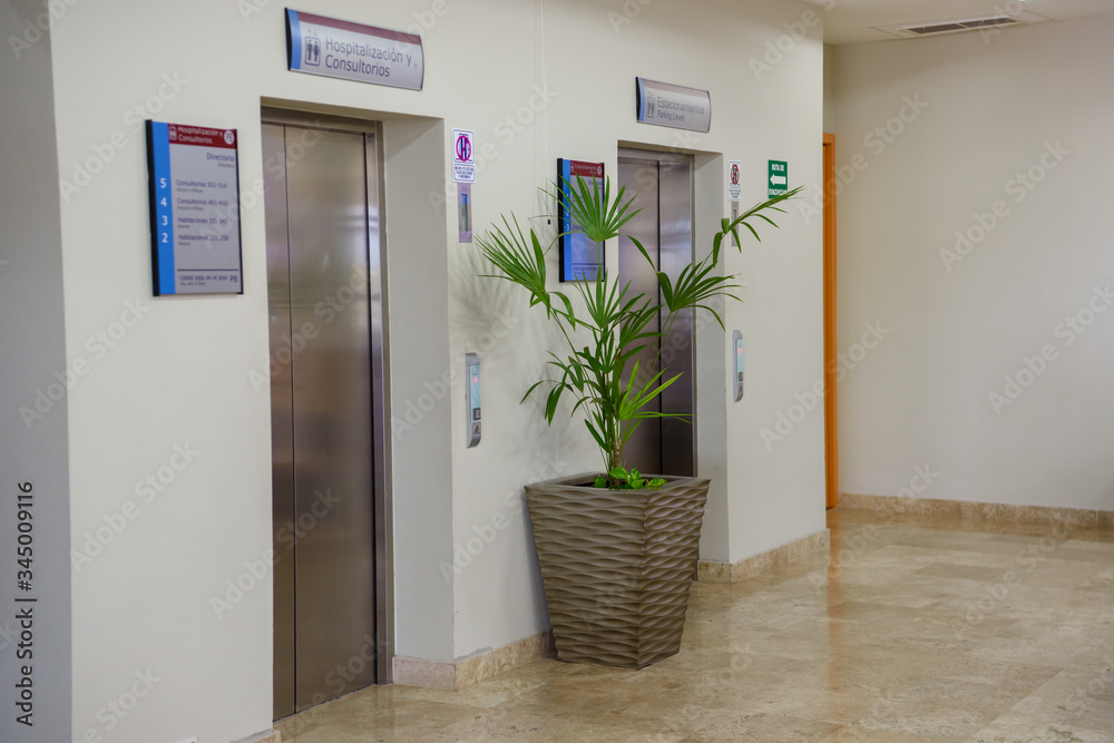 Elevator doors in the hospital corridor with signs. Stock Photo | Adobe ...