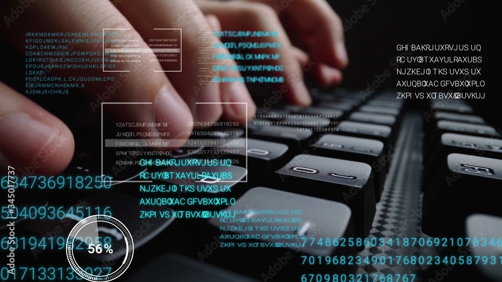 Man working on laptop computer keyboard with graphic user interface GUI ...