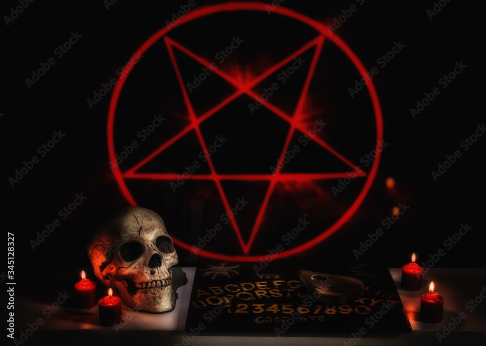A satanic seance ritual scene with a skull, ouija board, planchette and ...