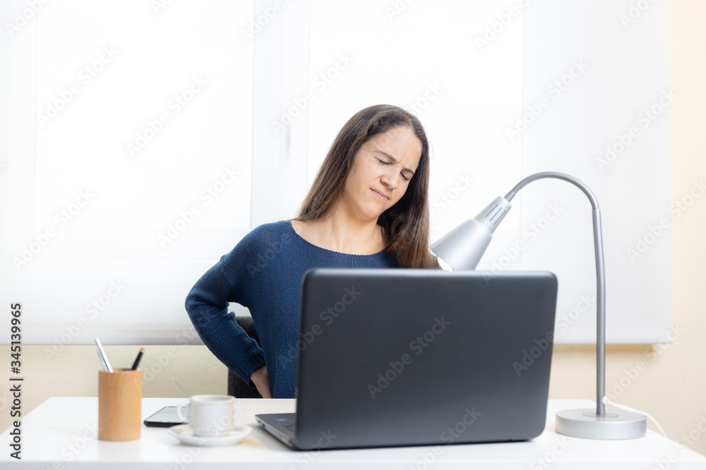 Teen student suffers back pain with computer at home Stock Photo ...