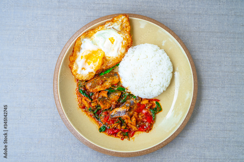 Stir-fried spicy canned fish with basil leaves served with Thai jasmine ...