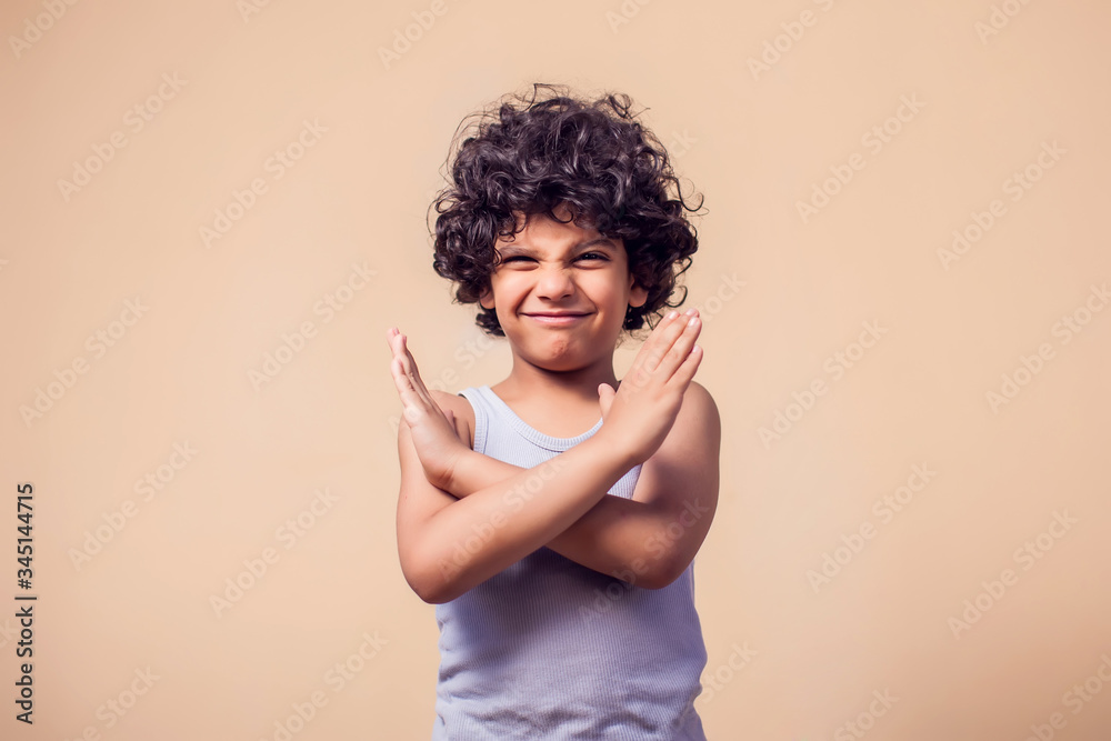 A portrait of angry kid boy showing stop gesture. Children and emotions ...
