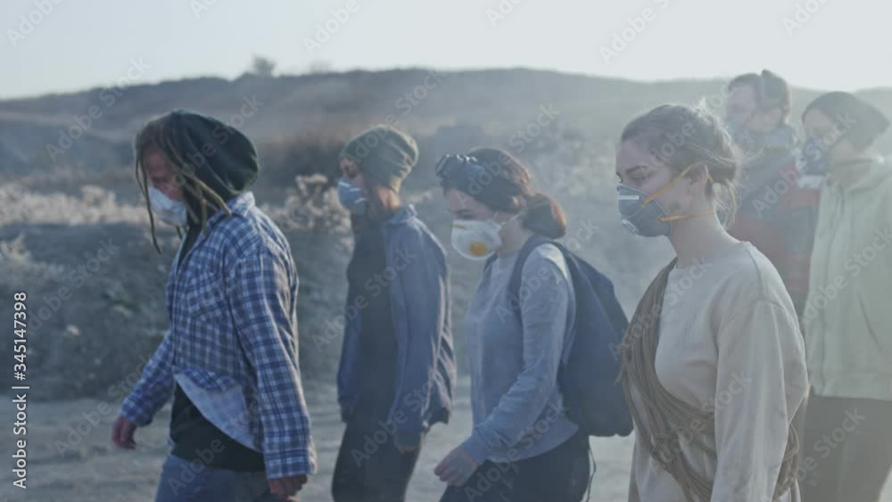 Group of young exhausted people in gas mask going through the toxic ...