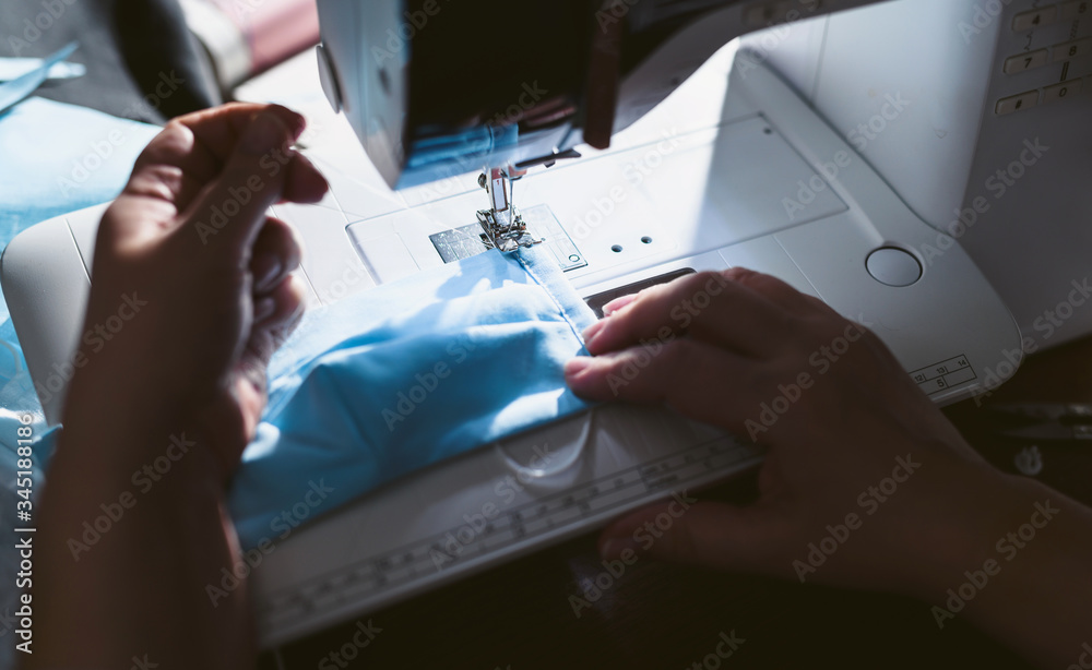 Close up sewing medical masks during the epidemic of the coronavirus ...