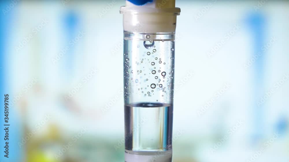Dripping medical perfusion close up equipment in clinic background ...