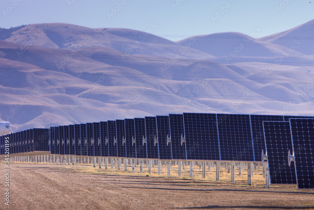 California Solar Farm with mountain range in background. Sustainable ...