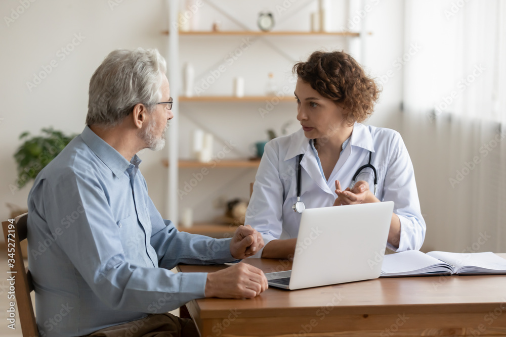 Female professional doctor explaining geriatric disease treatment ...