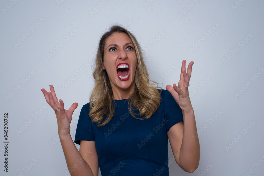 Screaming, hate, rage. Crying emotional angry woman screaming on blue ...