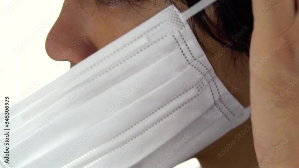Young asian man taking off face mask. Surgical face masks are used to ...