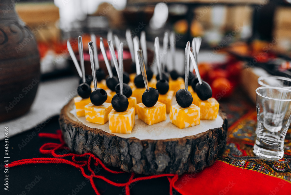Chunks of cheese on the buffet table. Cheese slicing. Festive table ...