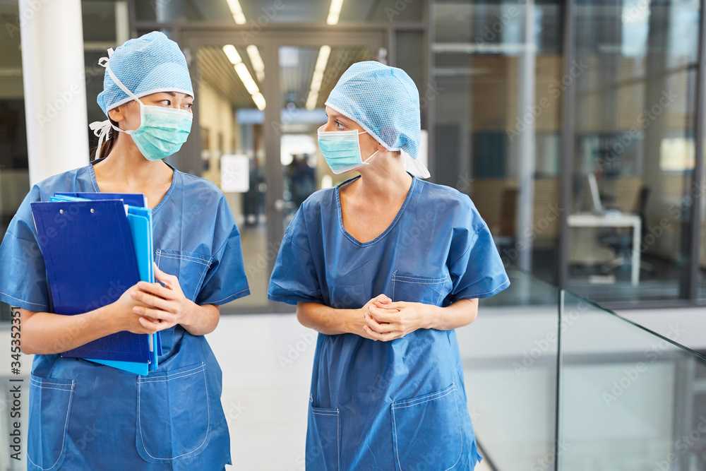 Two surgeons in blue surgical gown with surgical mask Stock Photo ...