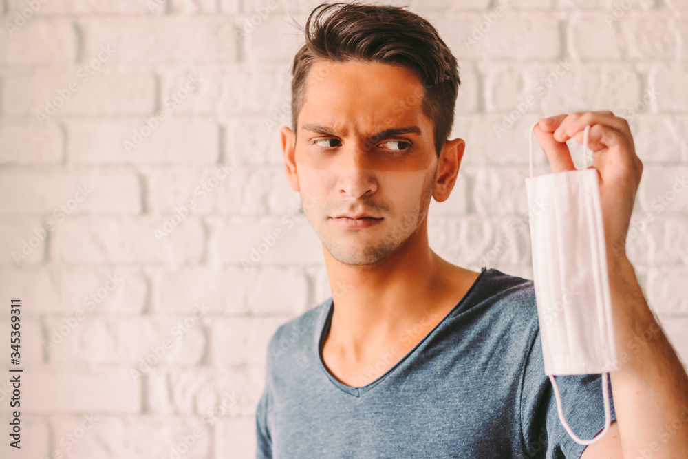 Portrait angry young man with funny sun tanned lines on face after ...