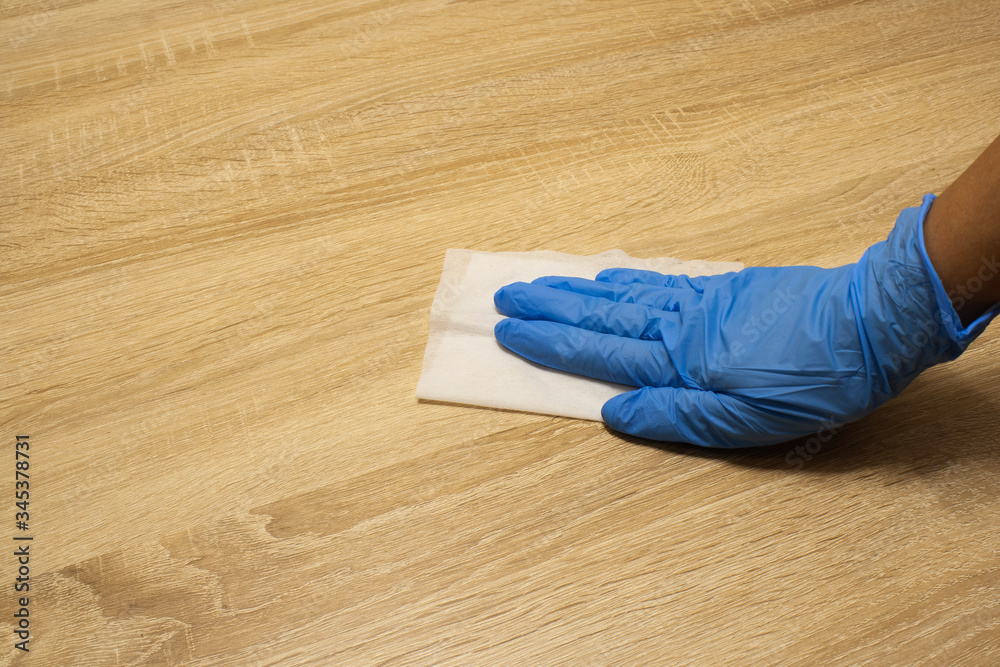 Cleaning home table, sanitizing kitchen wooden table surface with ...