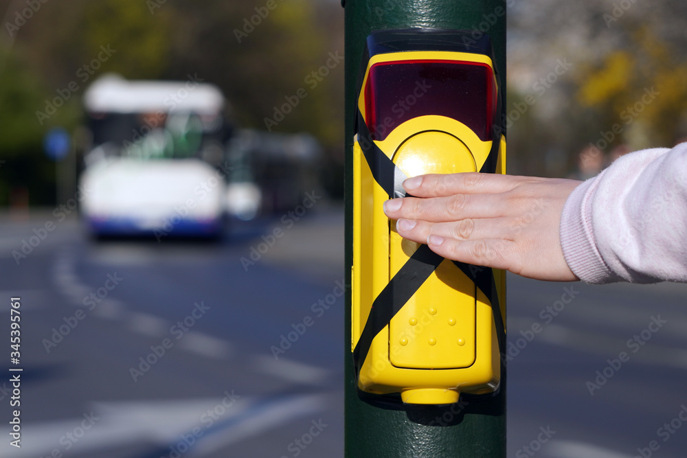 Turned off traffic light button for crossing the roadway with hand ...