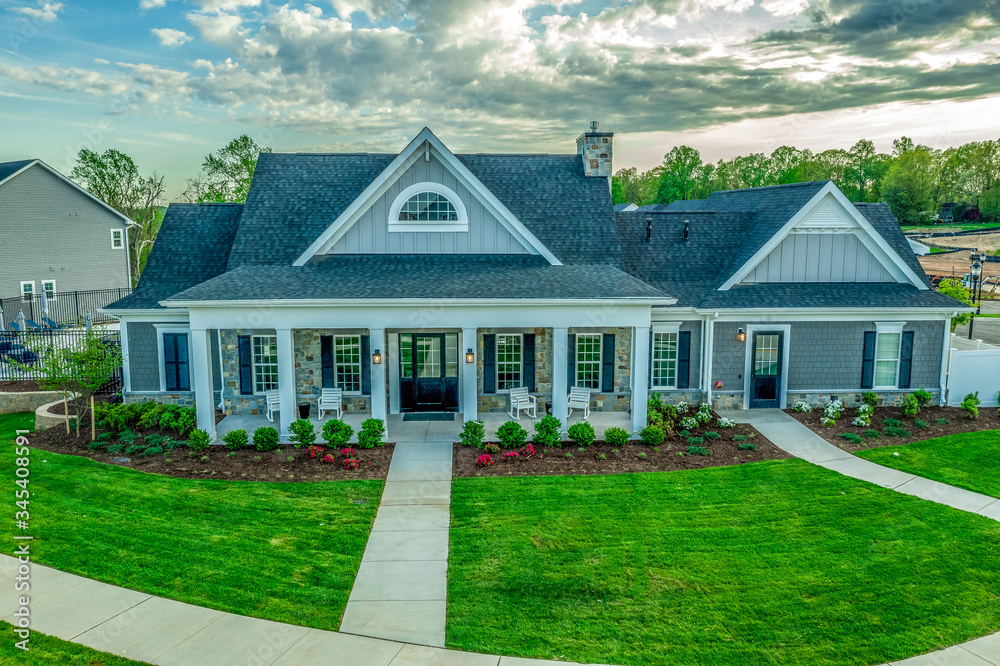 New construction community club house with white covered porch, gable ...