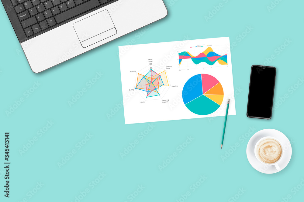 Top view office desk table with Smart phone, Chart, Notepad, Laptop ...