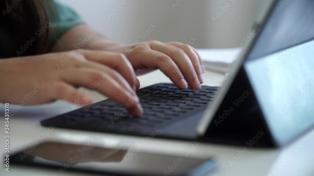 Close up video of the hands of a woman typing on the keyboard from her ...