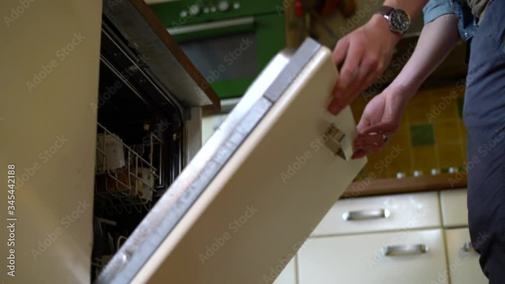 Turning on the dishwasher and closing it afterward. Stock Video | Adobe ...