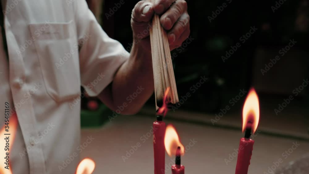 Close Up Hand Lighting Up Joss Sticks Incense from a Religious Candle ...