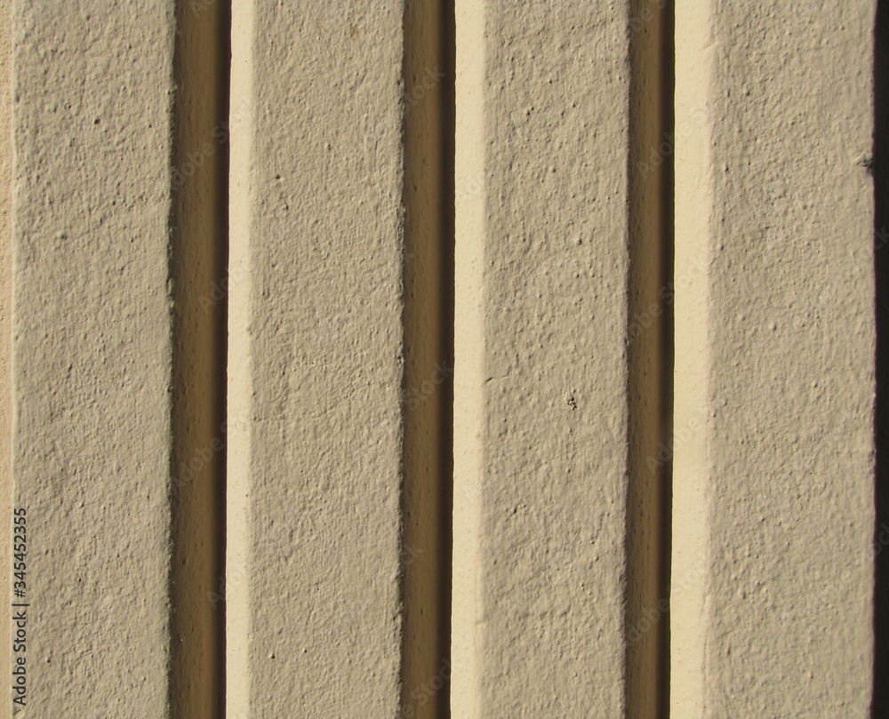 Plastered and painted wall textured background. Vertical molding on ...