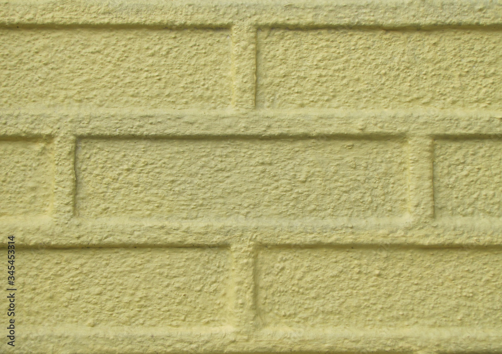 Yellow color painted brick texture background. Strange molding on ...