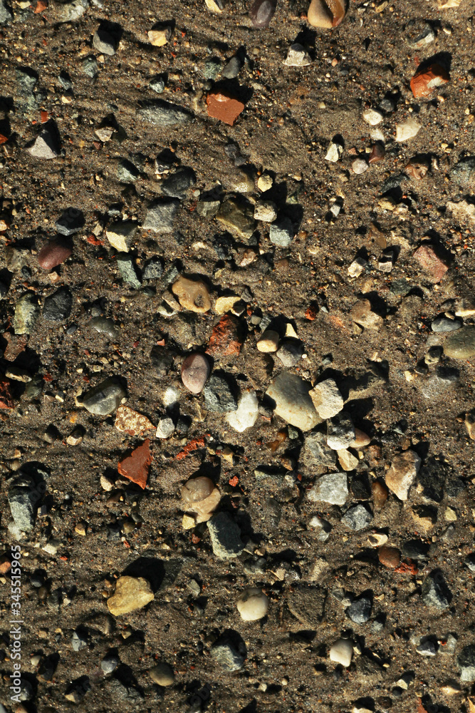 Small stones and sand. The natural texture of the soil. Shore of a ...