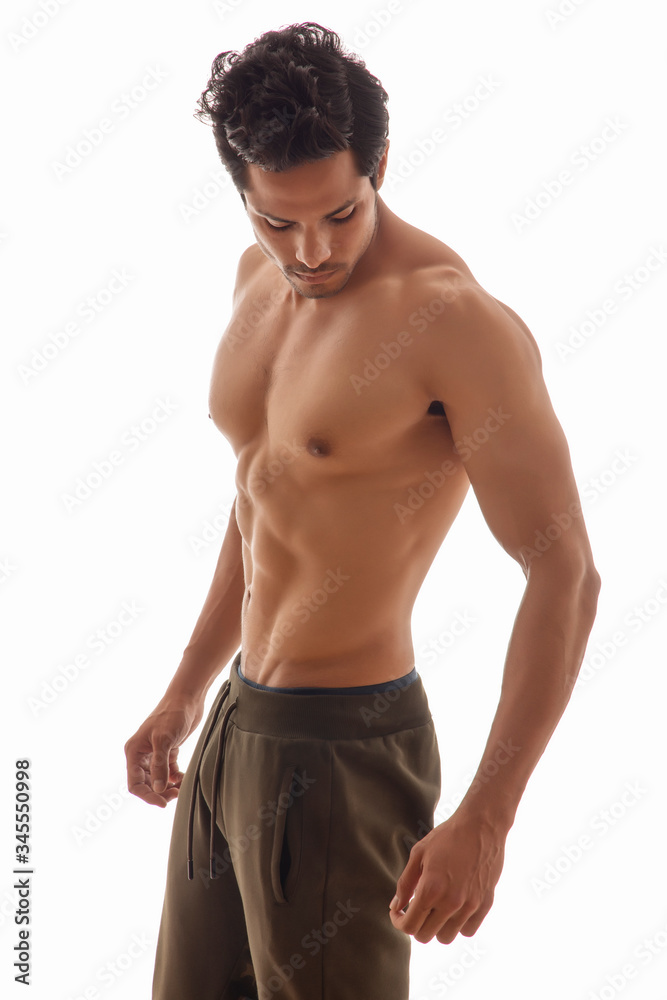 Man flexing his muscles in front of a white background. Stock Photo ...