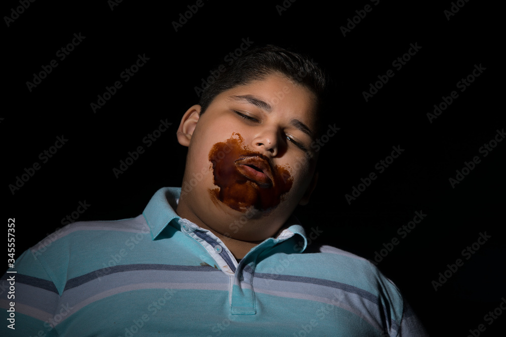 Young boy tired after having too much chocolates. (Obesity) Stock Photo ...