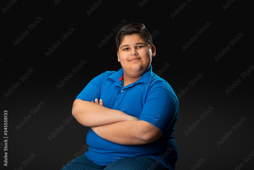 Portrait of a chubby boy smiling. (Obesity) Stock Photo | Adobe Stock