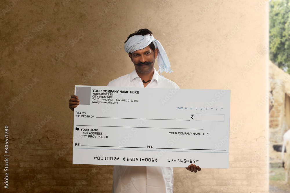 Indian rural man showing a bank cheque Stock Photo | Adobe Stock