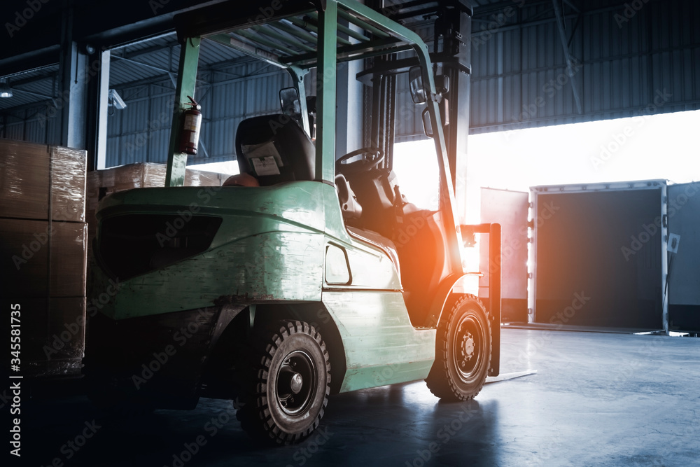 Interior of warehouse, forklift loading shipment goods, truck dock ...