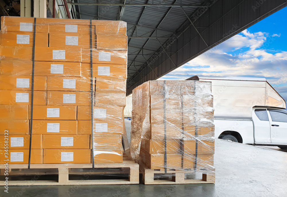 Interior of warehouse dock, stack of package boxes, large pallet ...