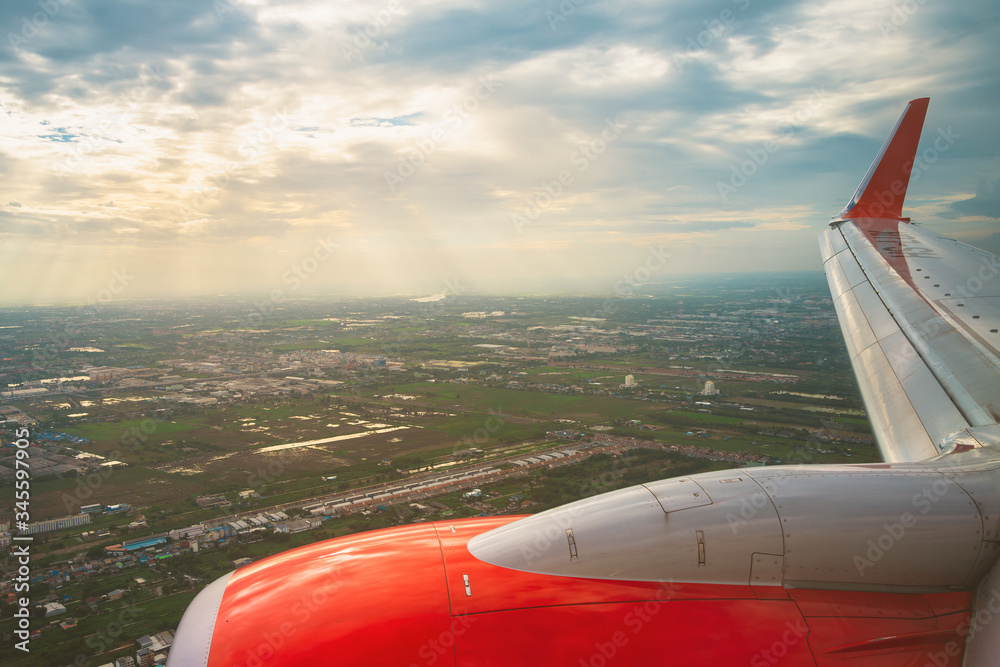 Beautiful scenic city view of sunset through the aircraft window ...