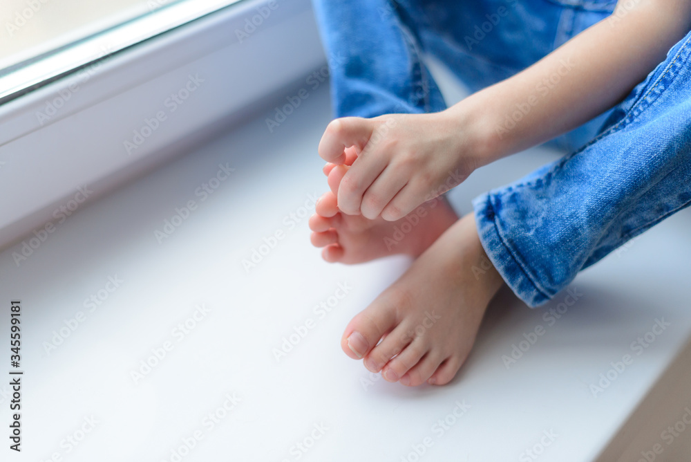 The child picks his toenails and his fingernail on his big toe is ...