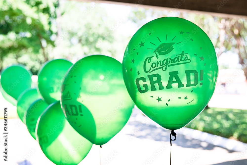 Close-up of Green Helium-filled graduation party balloons with Congrats ...