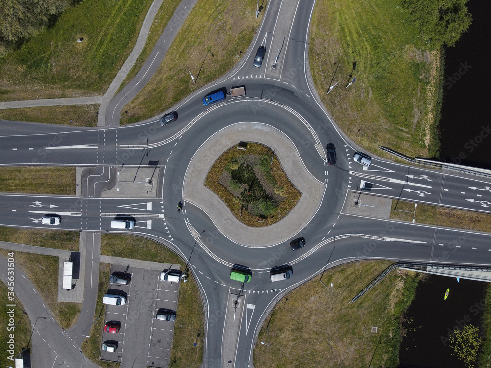 Aerial top down view of a traffic roundabout on a main road in an urban ...