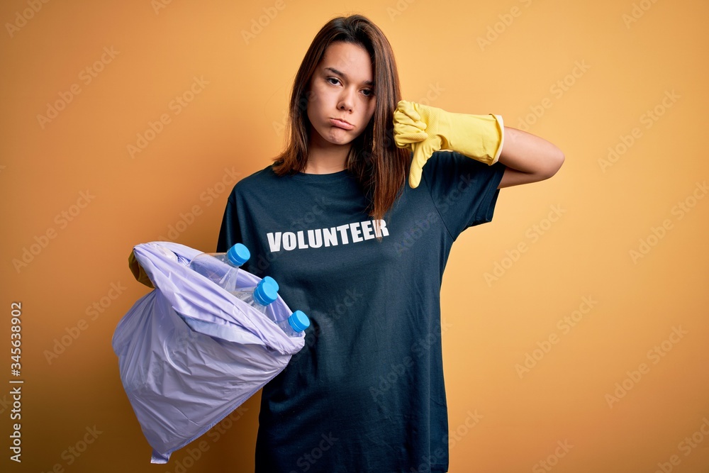 Beautiful volunteer girl caring environment doing volunteering holding ...