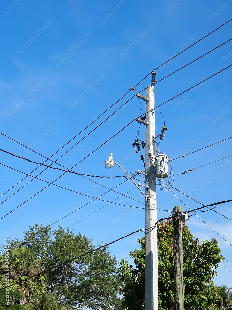 Neighborhood concrete utility pole with street light, transformer and ...