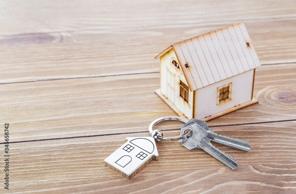 key chain with house symbol and keys on wooden background,Real estate ...
