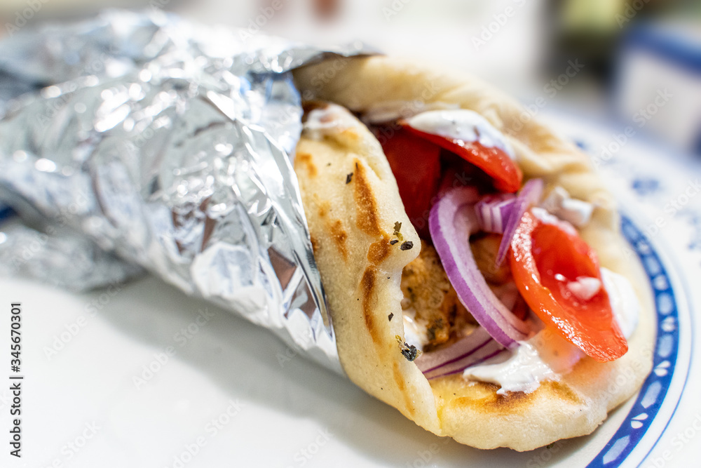 Homemade greek Pita Chicken Souvlaki Kalamaki wrap opened with Tzatziki ...