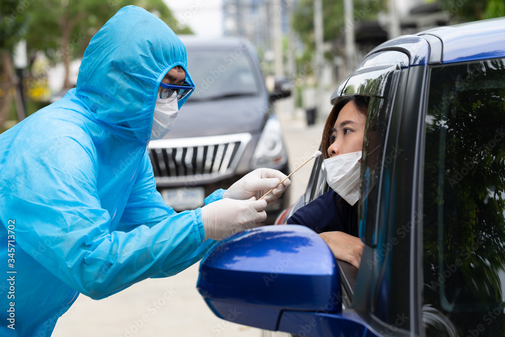 Nurse wearing PPE suit or Medical workers in full protective gear takes ...