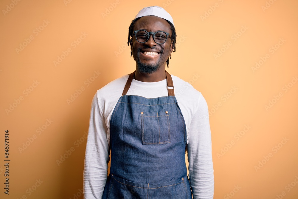 Young african american cooker man wearing apron and over isolated ...