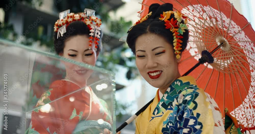 Attractive japanese geishas in traditional dresses walking around ...
